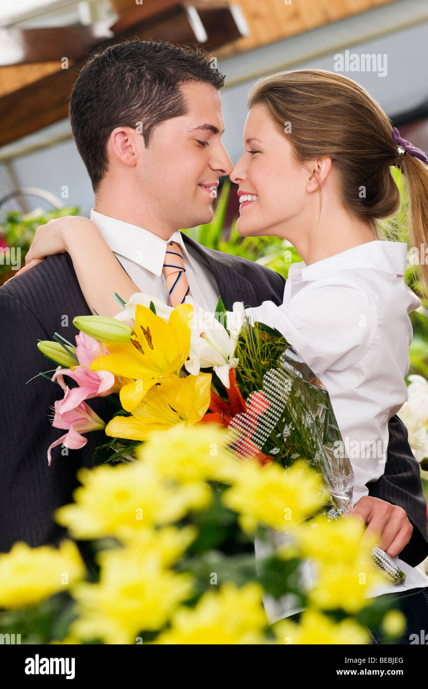 Couple romancing at a flower shop Stock Photo - Alamy