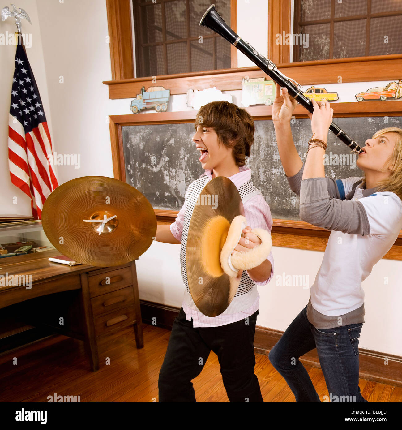 Two teenage boys playing musical instruments in a classroom Stock Photo ...