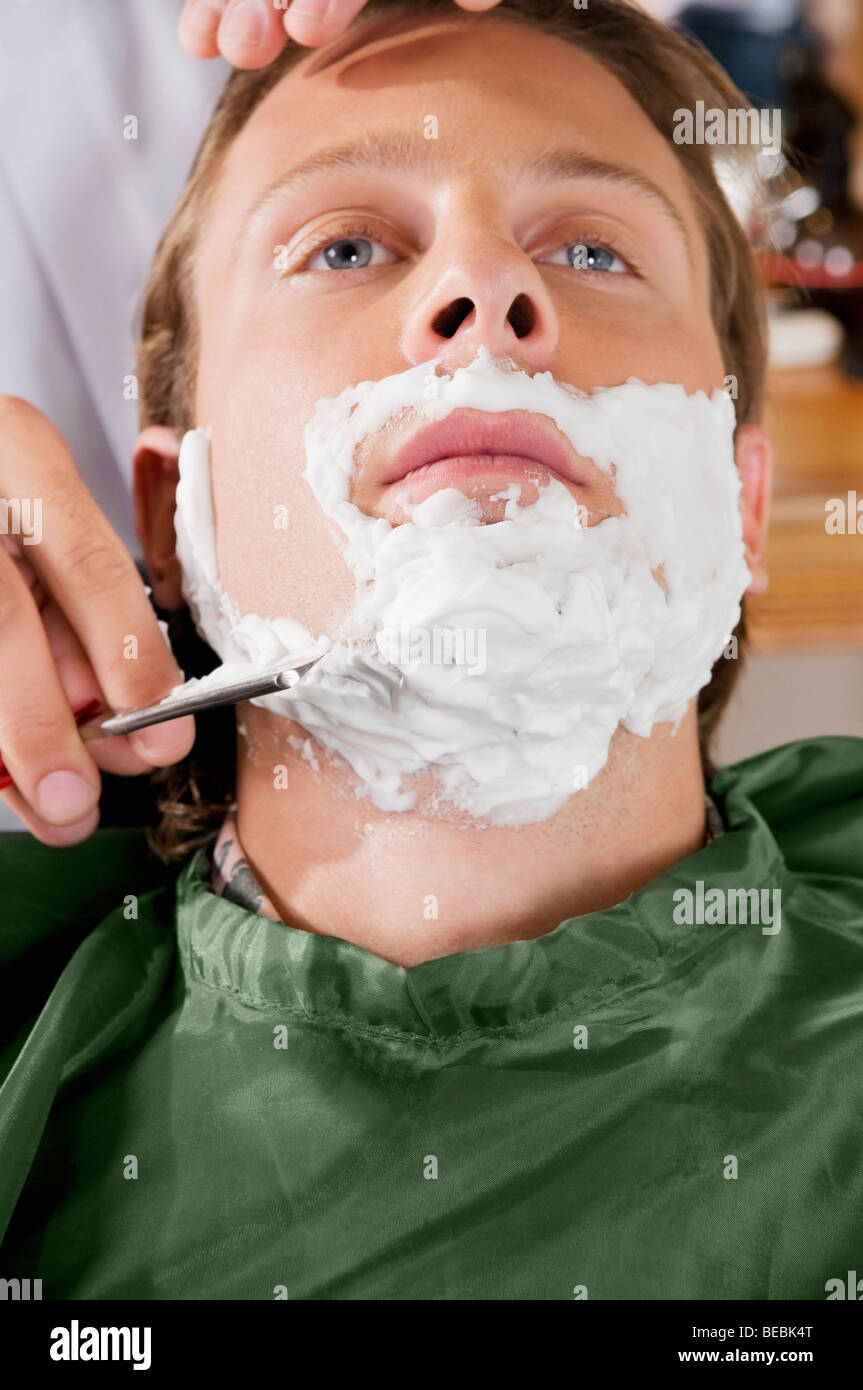 Man getting shaved in a salon Stock Photo - Alamy