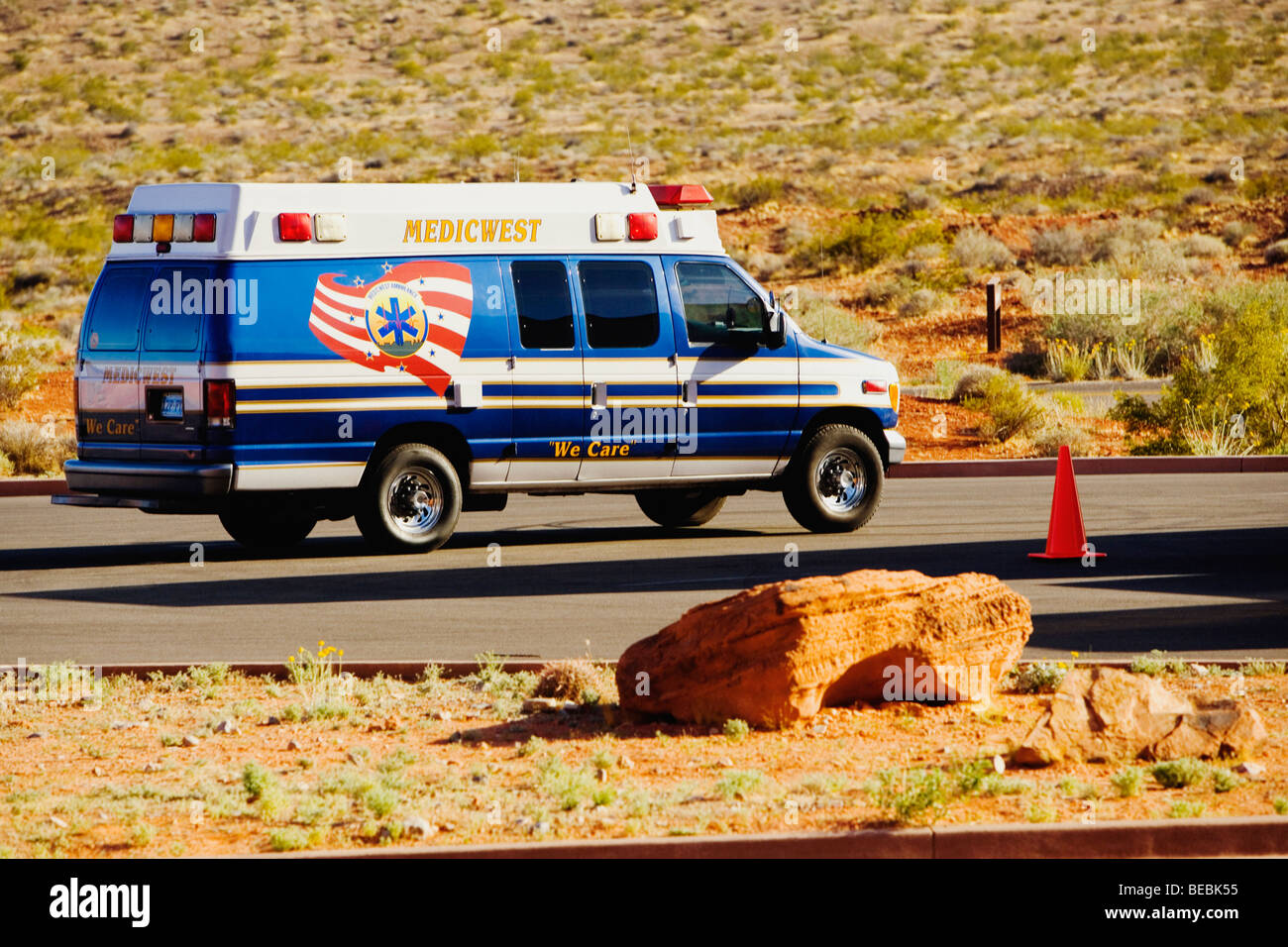 Ambulance on the road passing through an arid landscape, Las Vegas ...