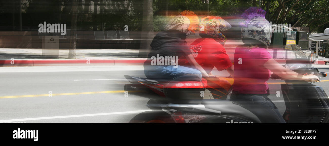 Three people racing on motor cycles Stock Photo - Alamy