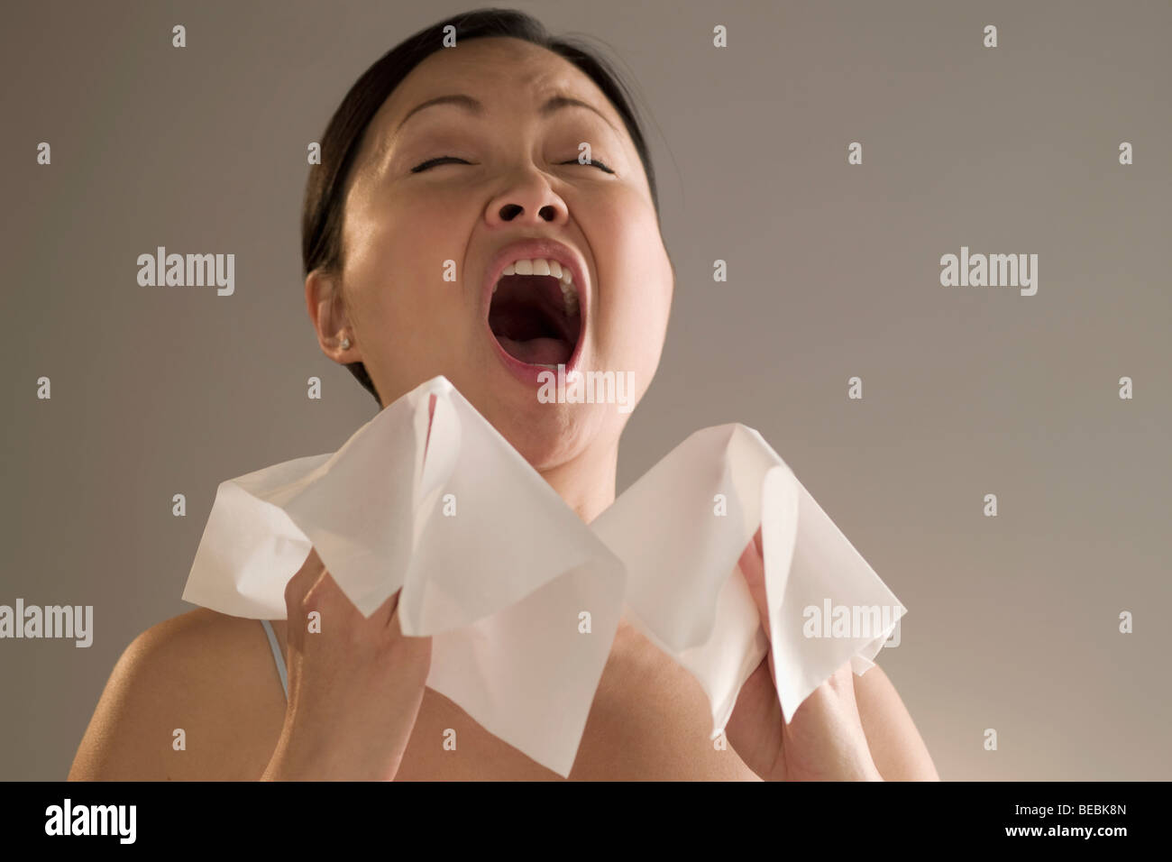 Close-up of a woman sneezing Stock Photo - Alamy
