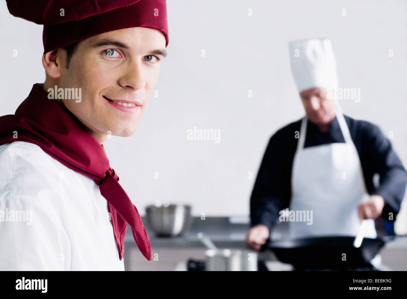 Two chefs cooking food in the kitchen Stock Photo - Alamy