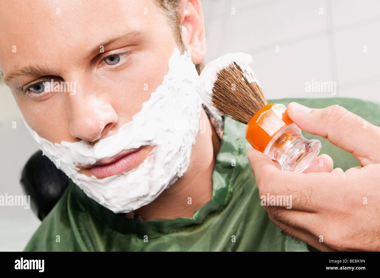 Man getting shaved in a salon Stock Photo - Alamy