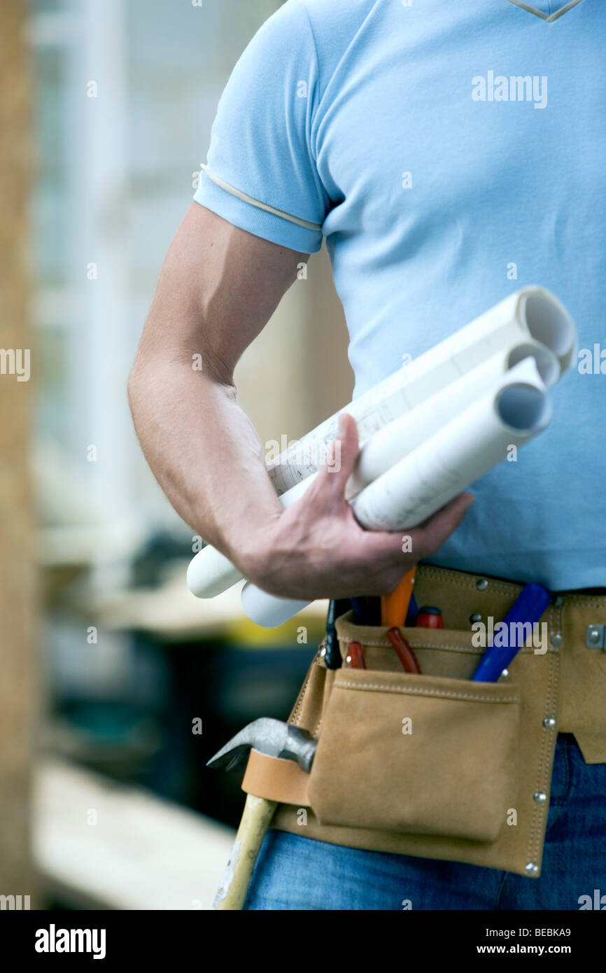 Detail of a builder's hand with plans Stock Photo - Alamy