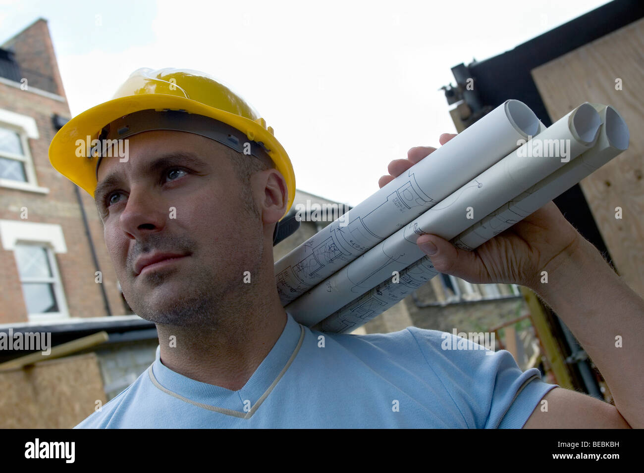 Builder with plans Stock Photo - Alamy