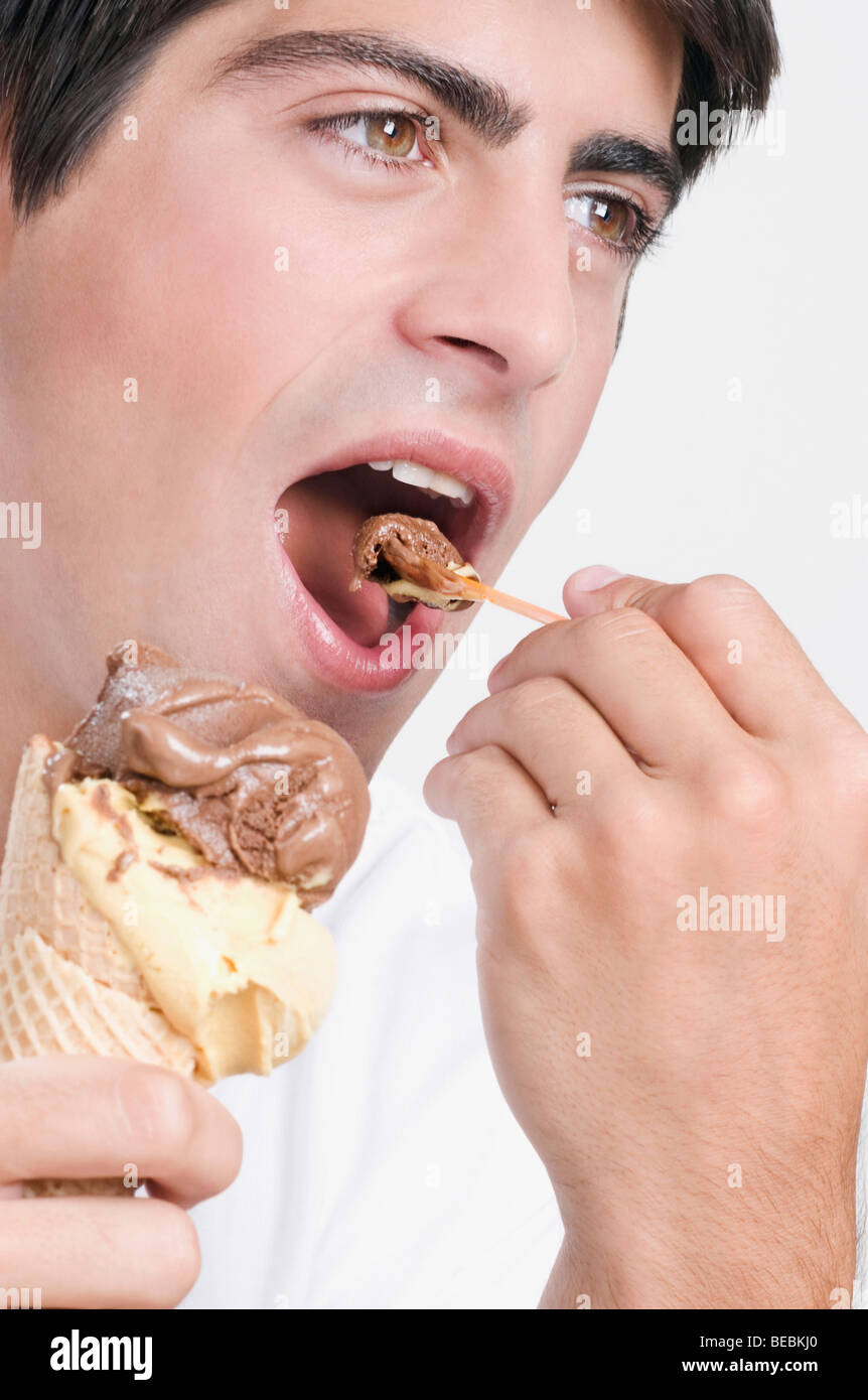 Close-up of a man eating an ice cream Stock Photo - Alamy