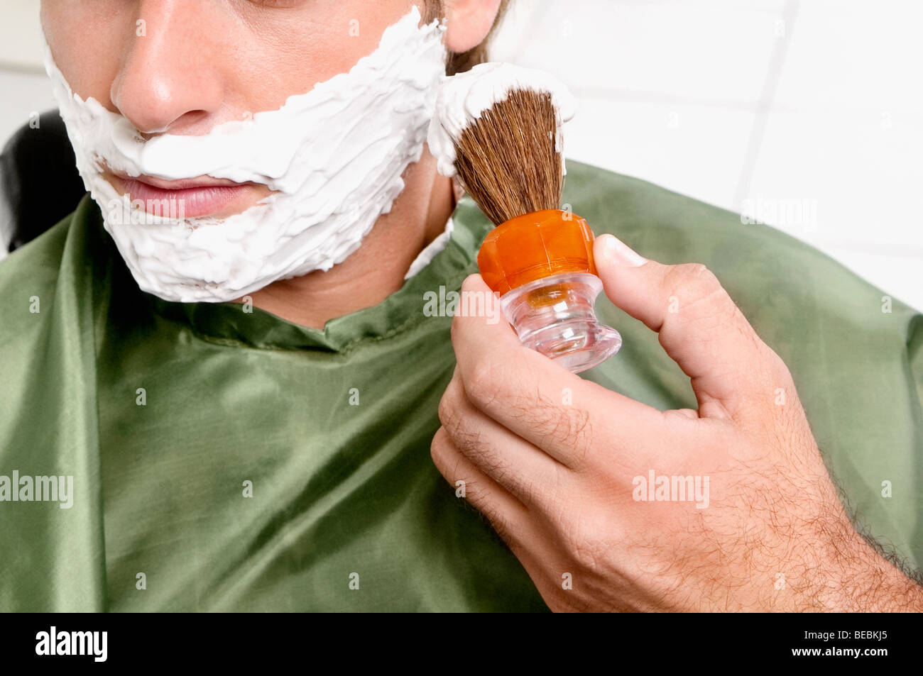 Man getting shaved in a salon Stock Photo - Alamy