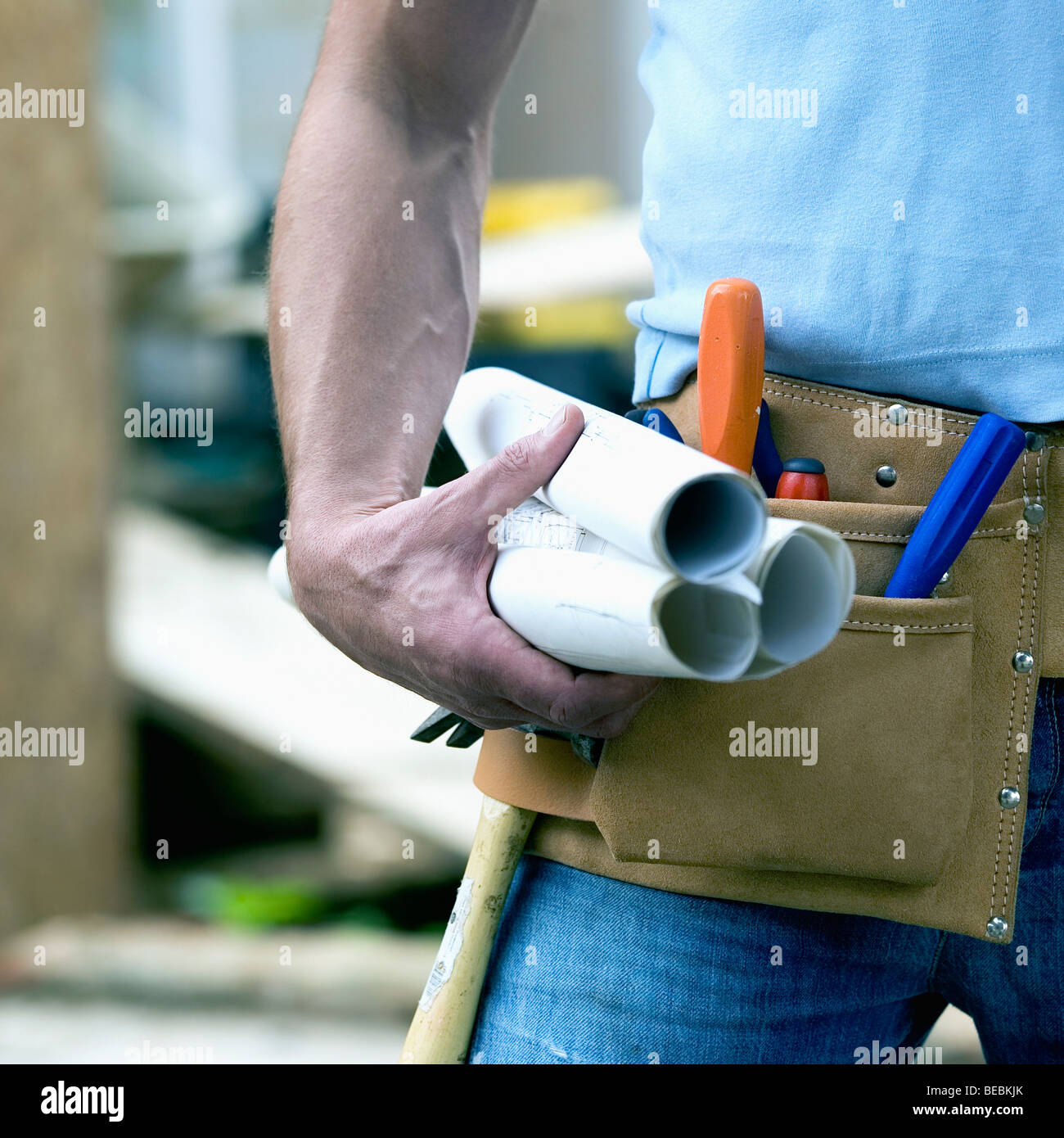 Detail of a builder's hand with plans Stock Photo - Alamy