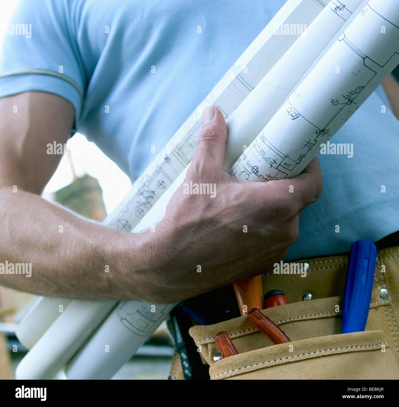 Detail of a builder's hand with plans Stock Photo - Alamy