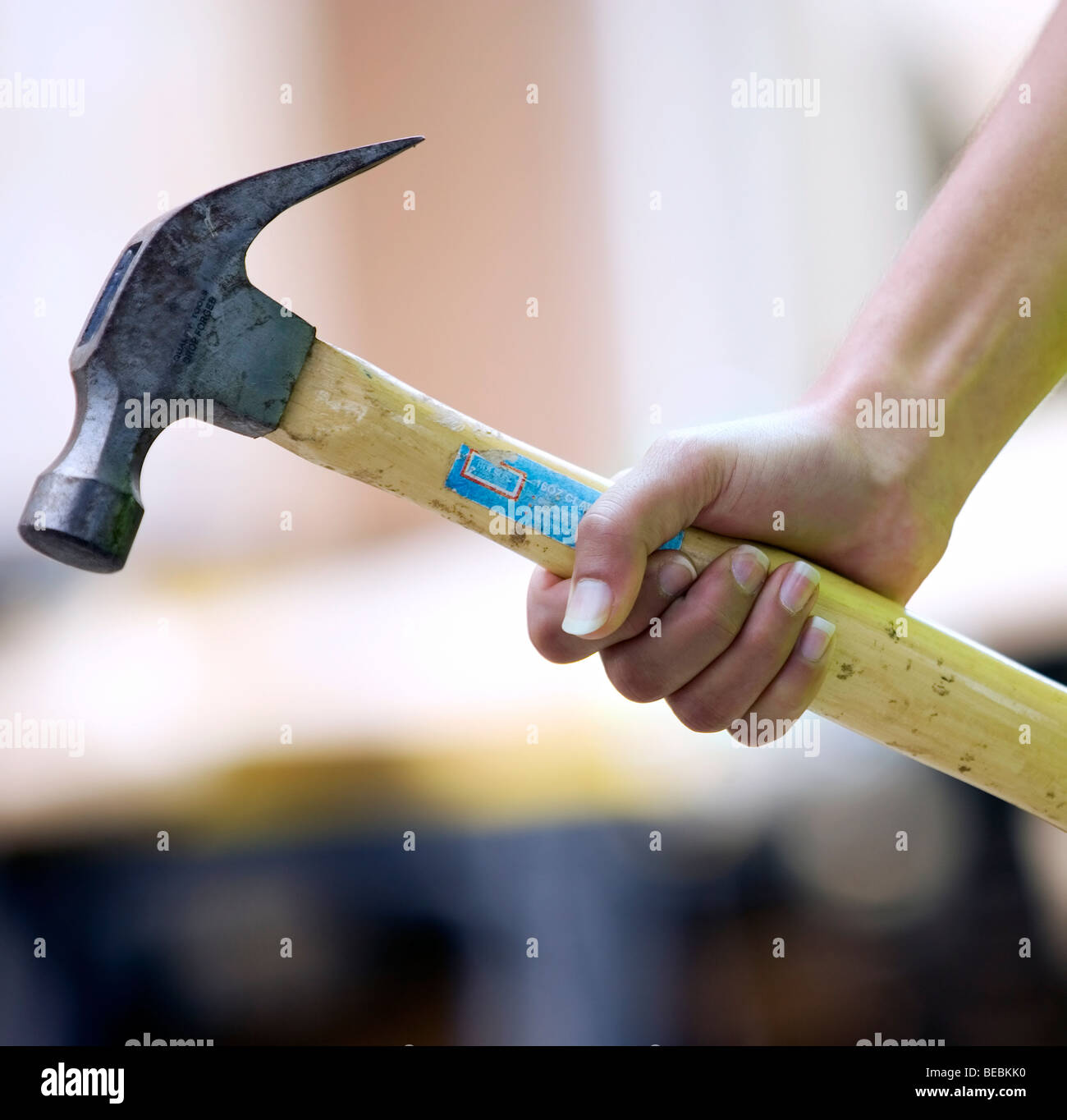 Detail of a woman's hand with hammer Stock Photo - Alamy