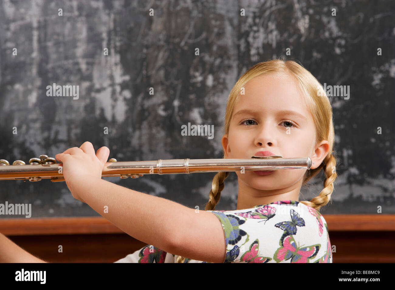 Schoolgirl playing flute in classroom hi-res stock photography and ...