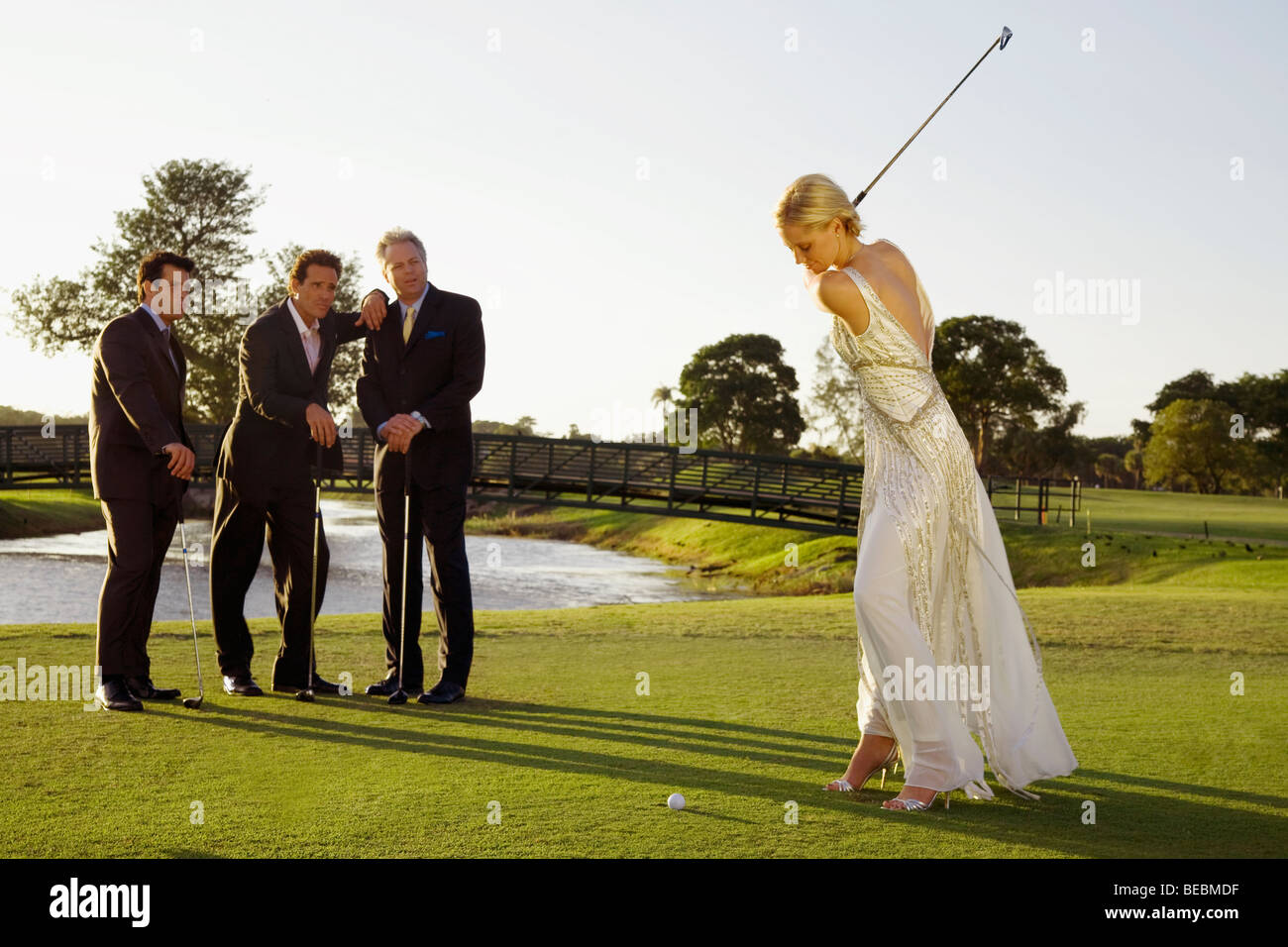 Bride playing golf and three men watching her, Biltmore Golf Course ...