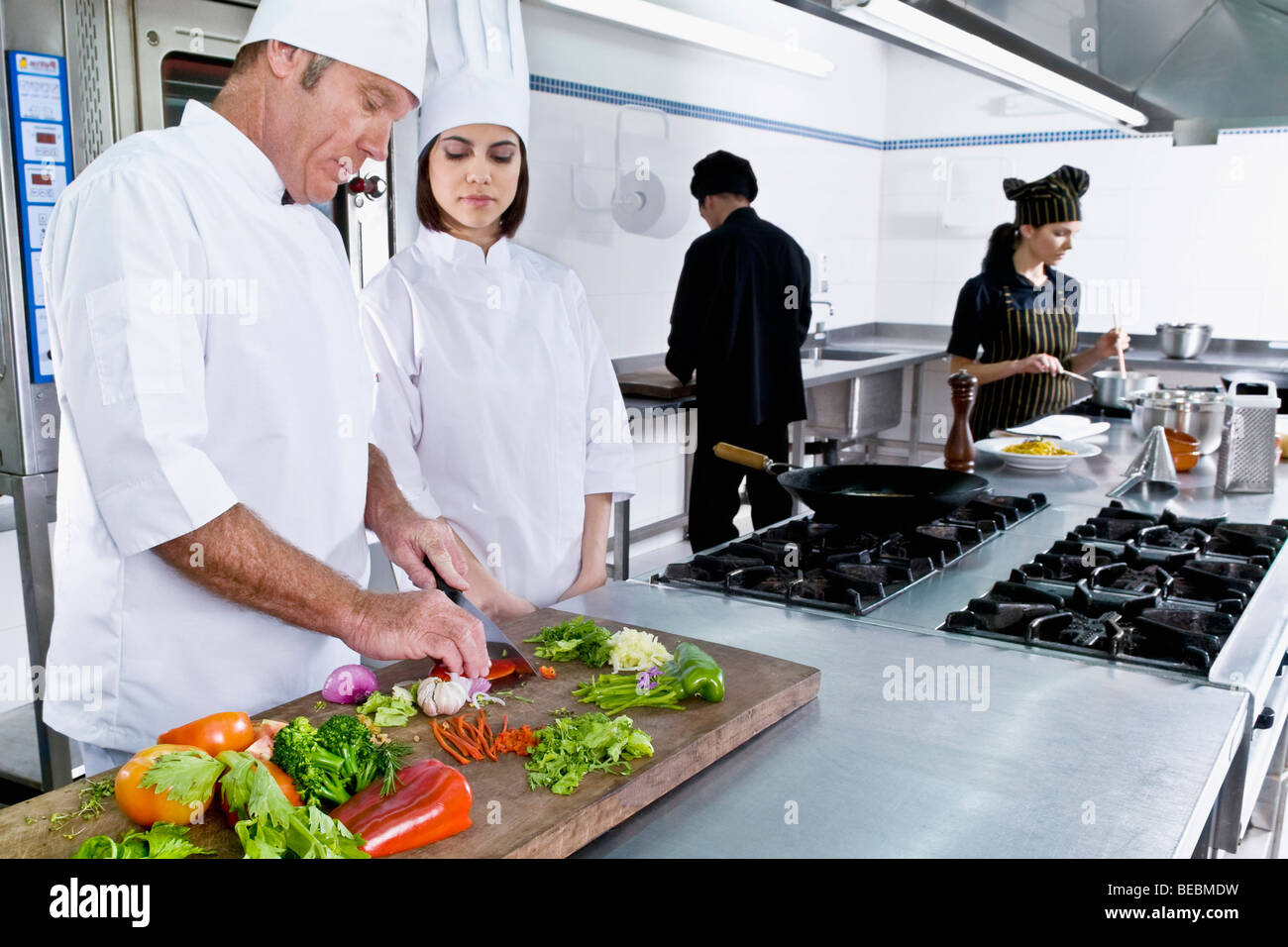 Chefs cooking food in the kitchen Stock Photo - Alamy