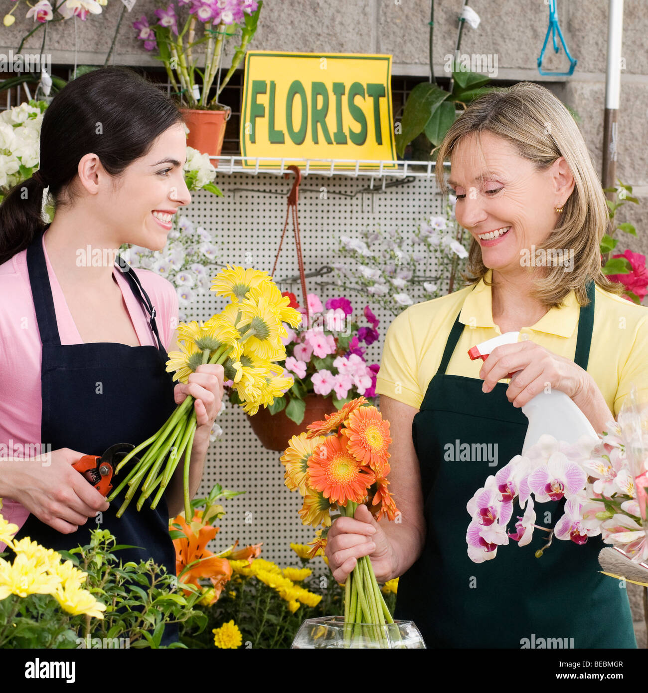 Two female florists working in a flower shop and smiling Stock Photo ...