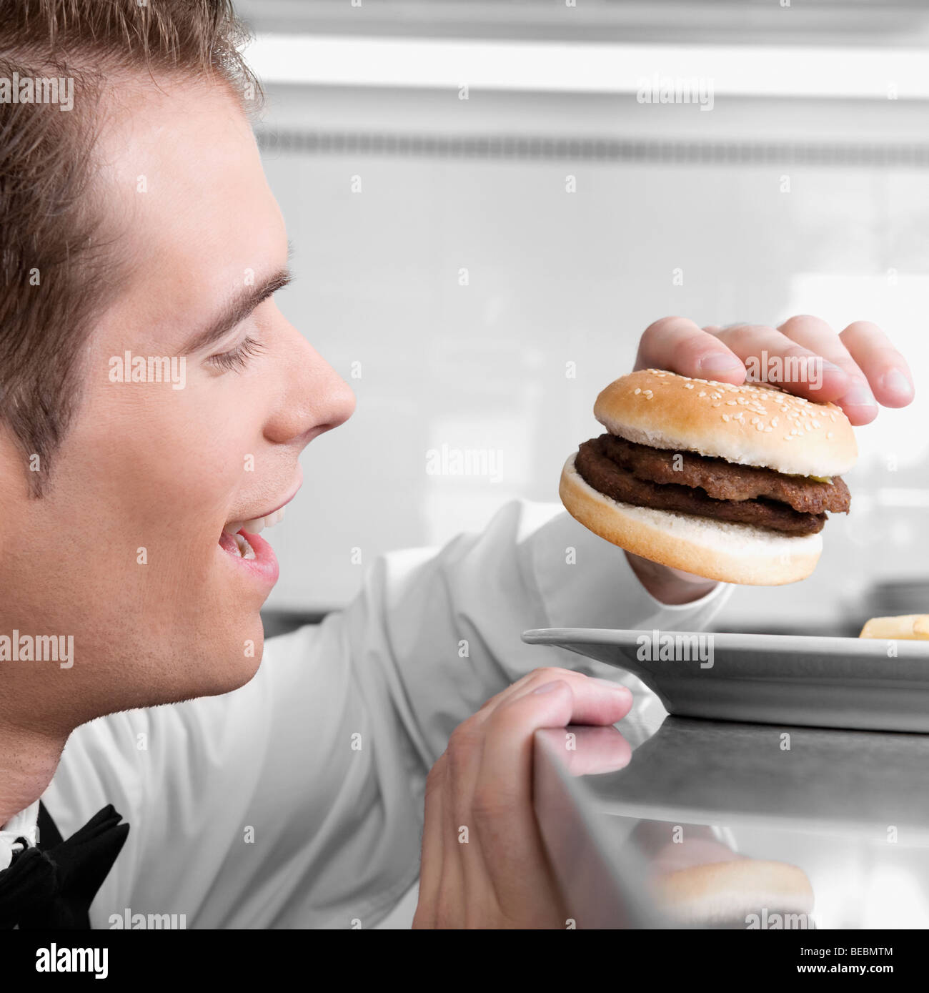 Man eating burger side hi-res stock photography and images - Alamy