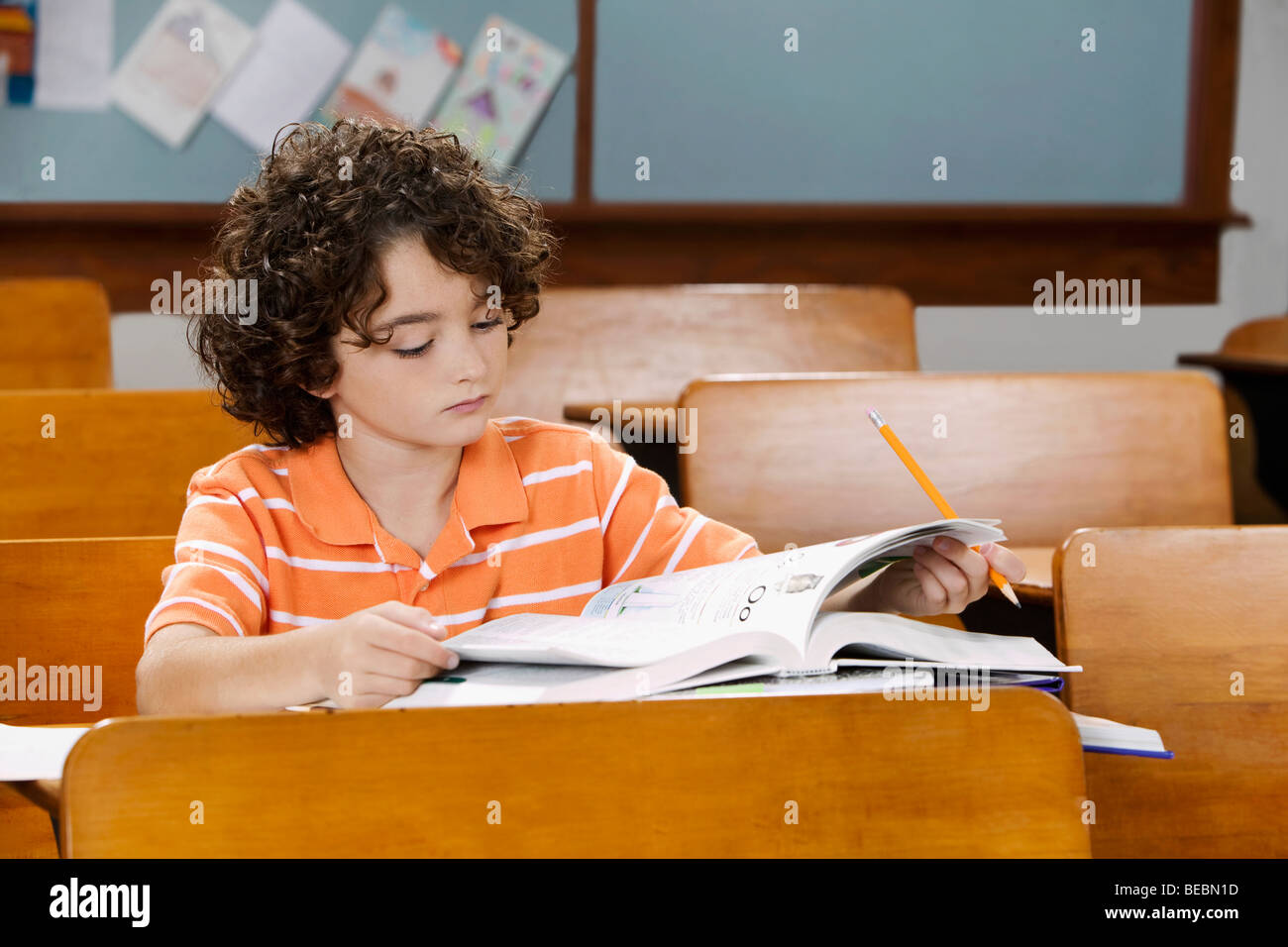Schoolboy studying in a classroom Stock Photo - Alamy