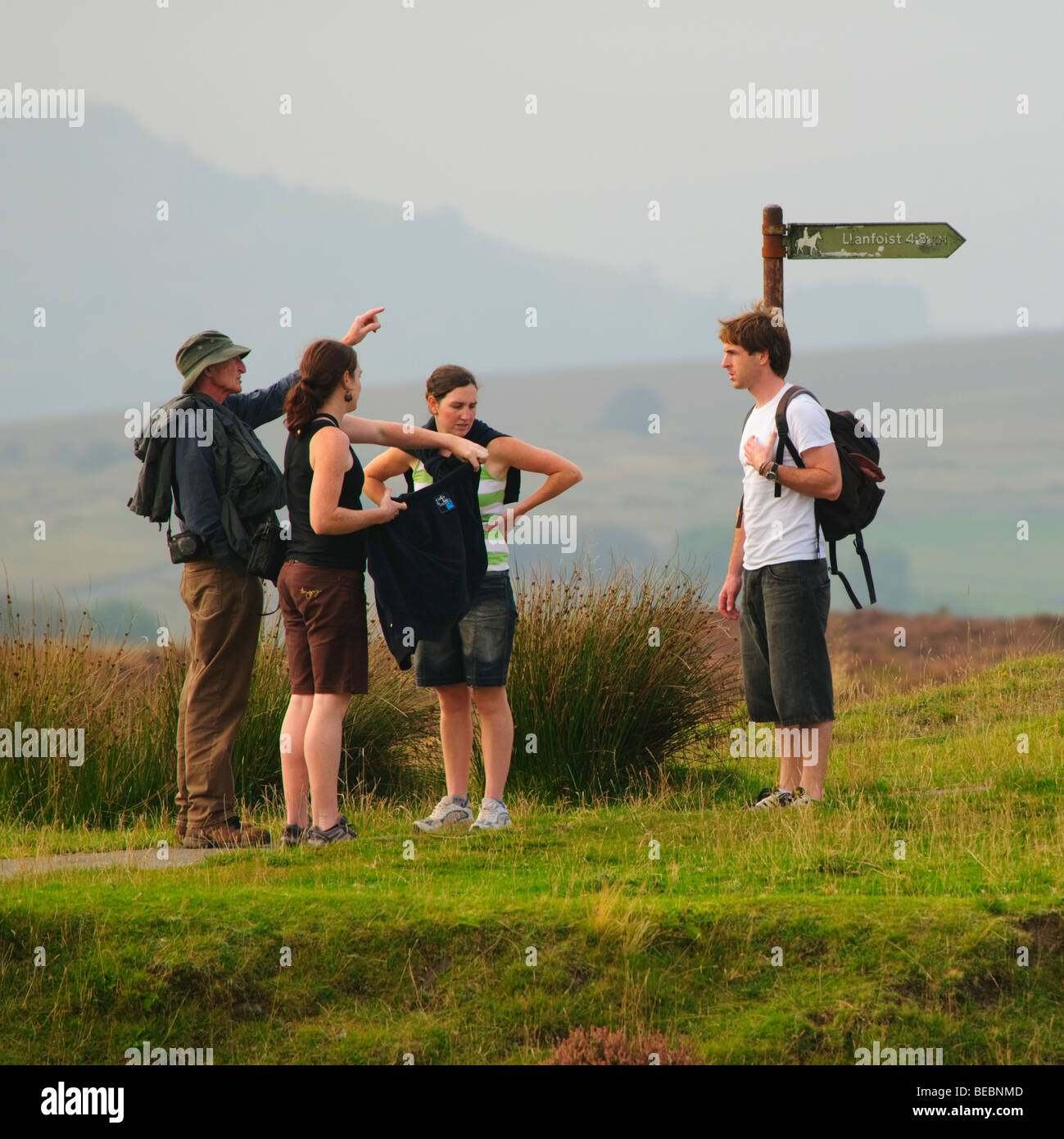 A group of four people walking in the countryside on The Blorenge hill ...