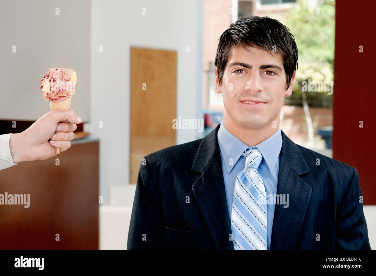 Businessman smiling in an ice cream parlor Stock Photo - Alamy