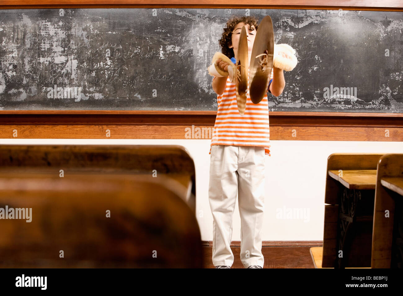 Schoolboy playing cymbals in a classroom Stock Photo - Alamy