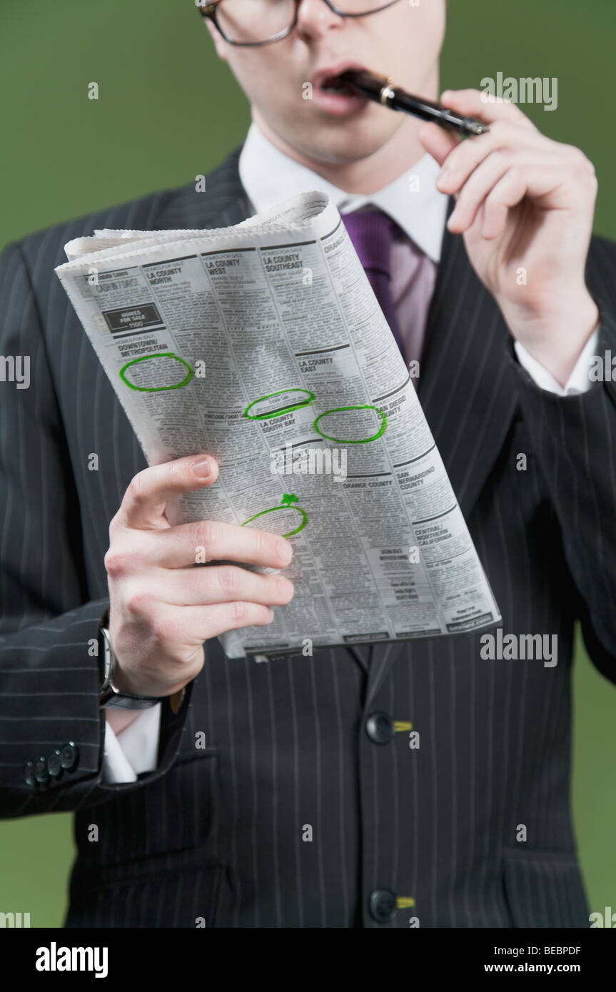 Close-up of a businessman marking on a newspaper Stock Photo - Alamy