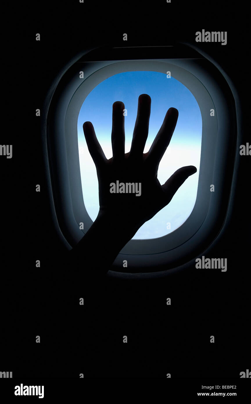Person's hand in front of an airplane window Stock Photo - Alamy