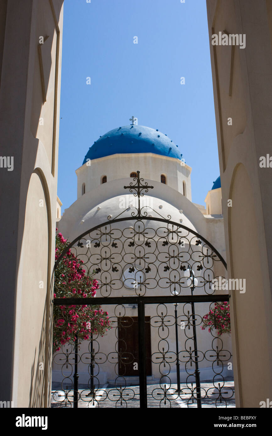 Beautiful blue church roofs, through stone archway, Perissa, Santorini ...
