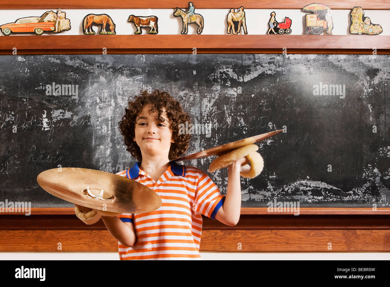 Schoolboy playing cymbals in a classroom Stock Photo - Alamy