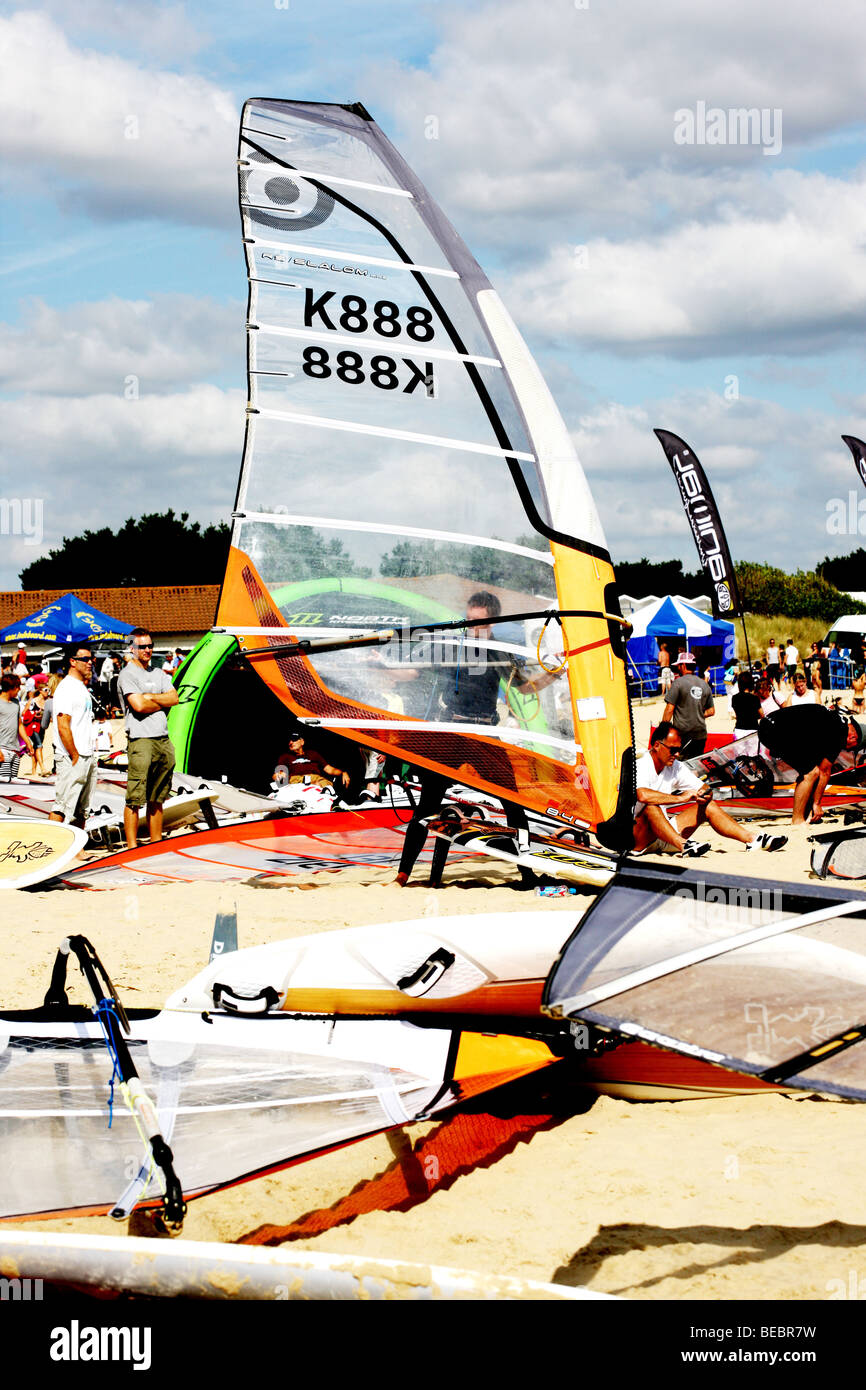 Colourful Windsurfing Boards And Sails Laying On A Sandy Beach Waiting ...