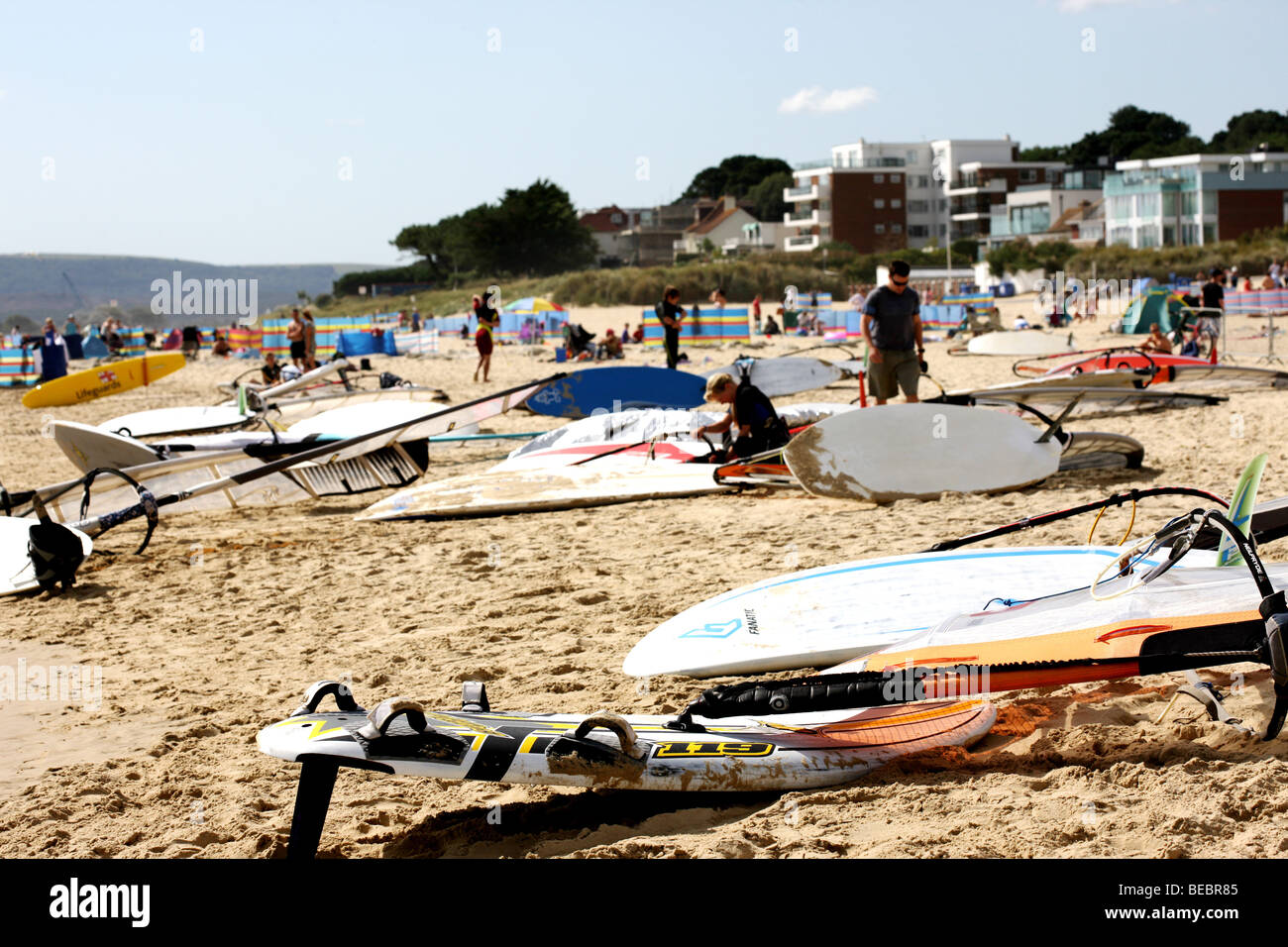 Colourful Windsurfing Boards And Sails Laying On A Sandy Beach Waiting ...