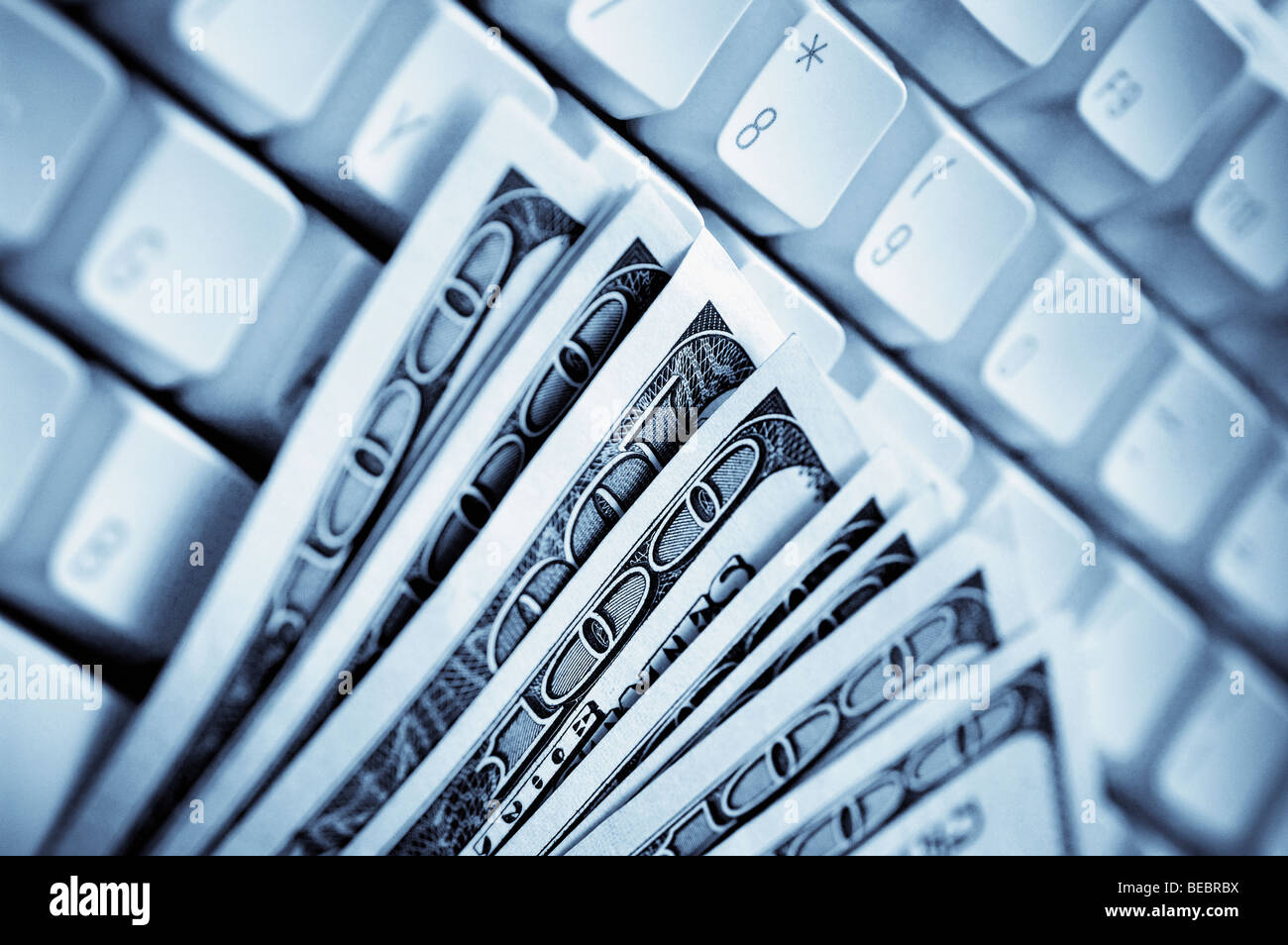 Close-up of US paper currency on a computer keyboard Stock Photo - Alamy