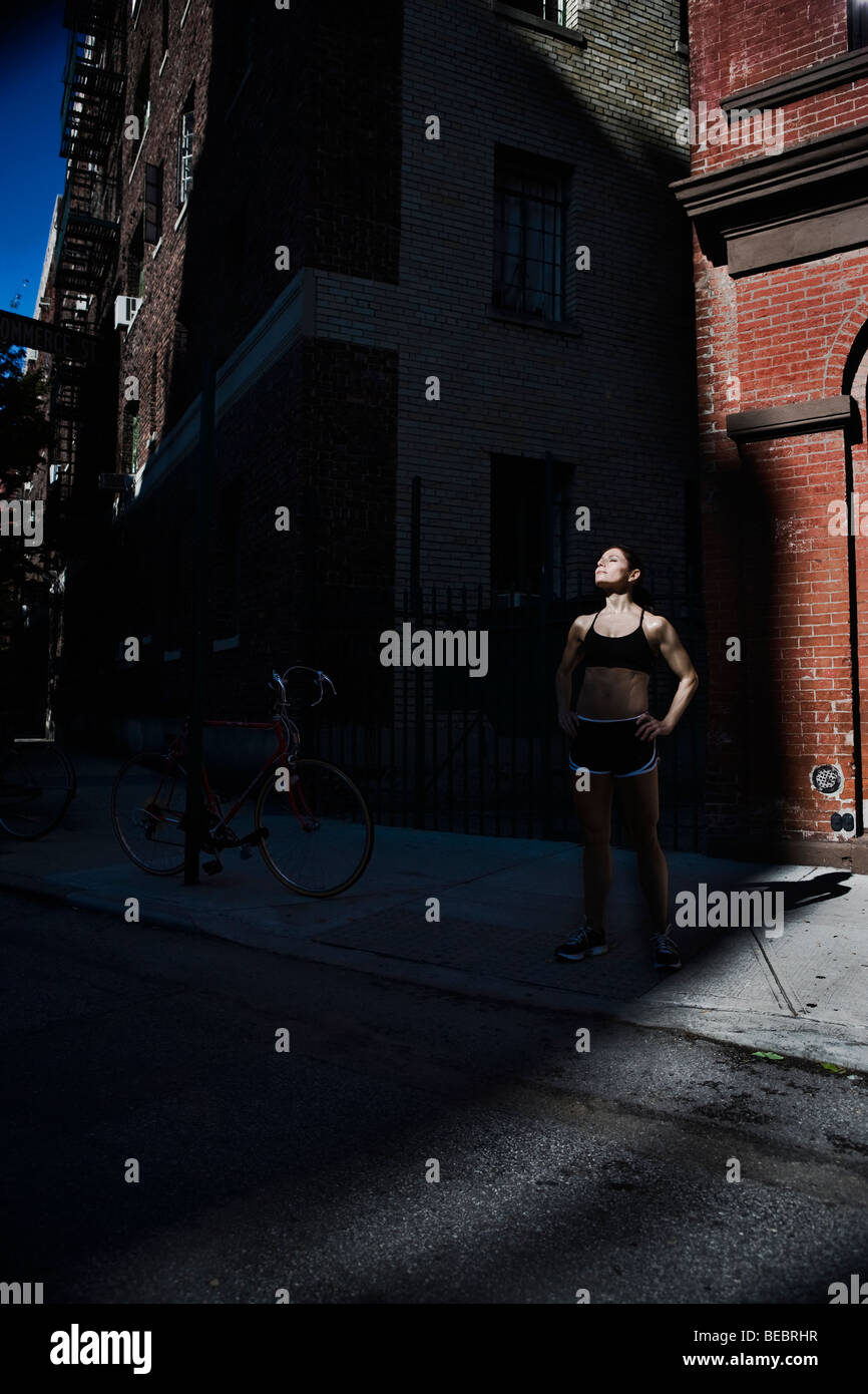 Woman exercising with arms akimbo Stock Photo - Alamy