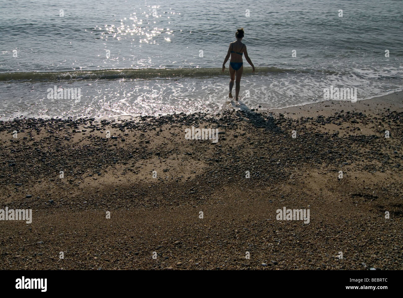 Bather entering into the sea for an early morning dip at Aldeburgh on ...