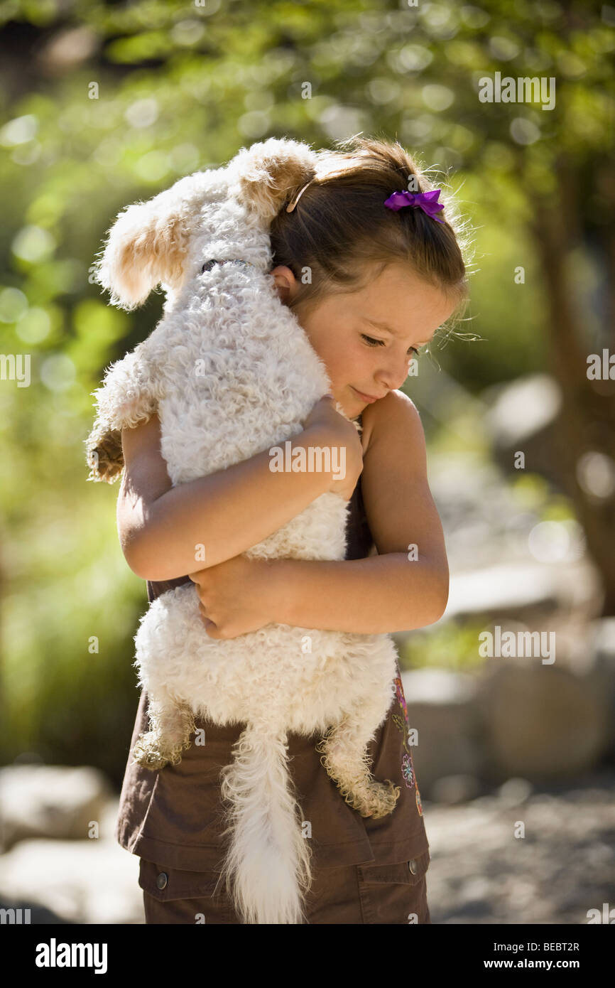Girl carrying a dog Stock Photo - Alamy