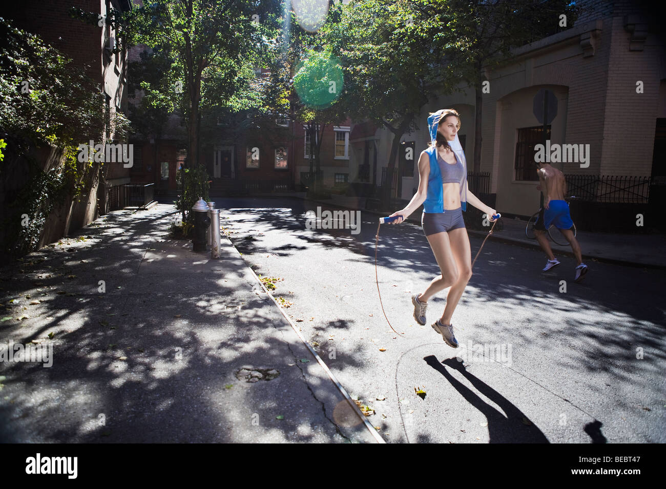 Woman jumping with a rope in the street Stock Photo - Alamy