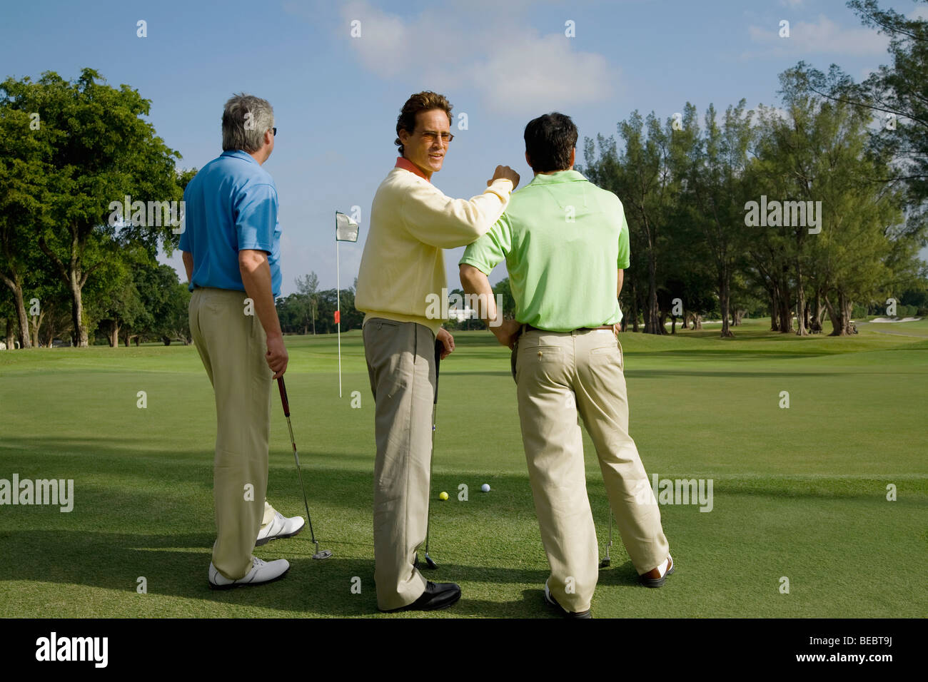 Three golfer standing in a golf course, Biltmore Golf Course, Coral ...