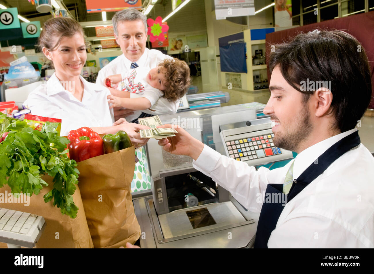 Customers at checkout counter in a supermarket Stock Photo - Alamy
