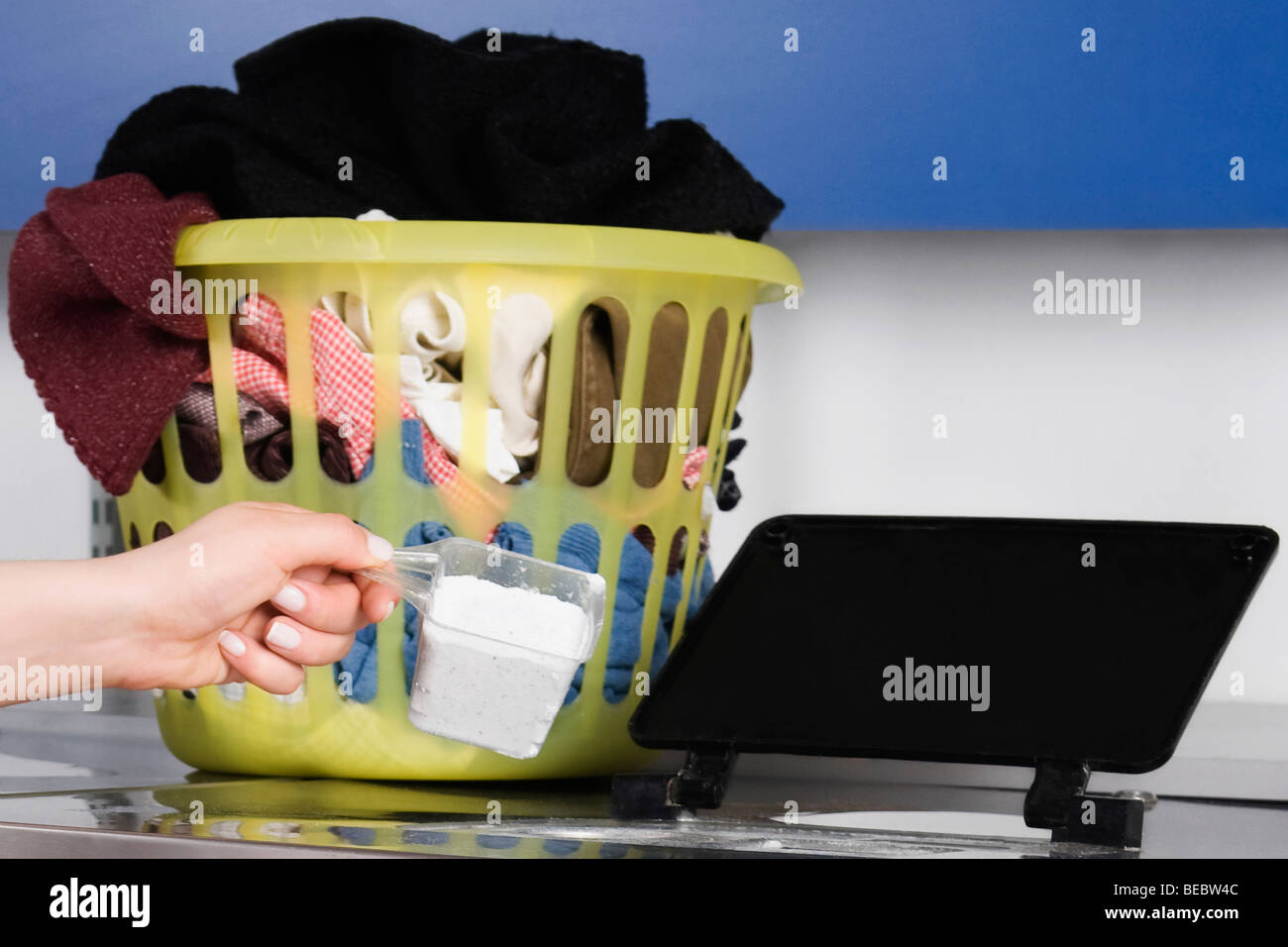 Woman putting detergent into a washing machine Stock Photo - Alamy