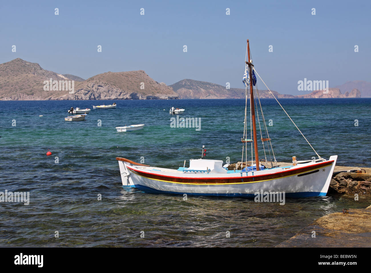 A fishing boat at the coast of Milos island in Greece Stock Photo - Alamy