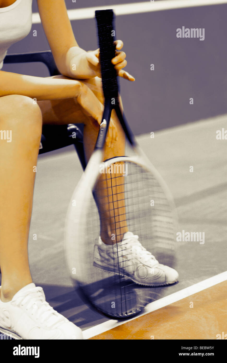 Woman's hand holding a tennis racket and sitting on a chair Stock Photo ...