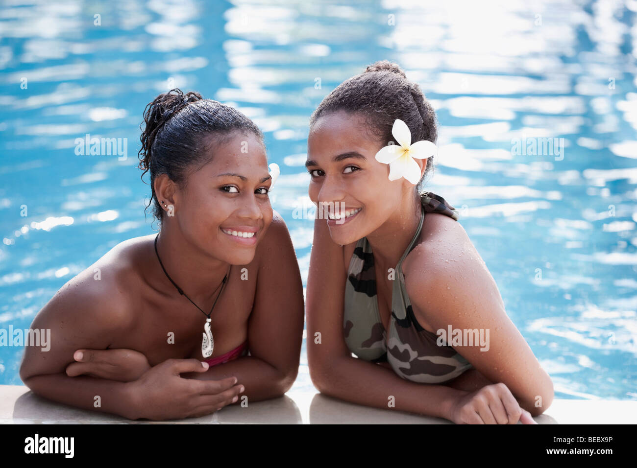 Portrait of two female friends smiling in a swimming pool Stock Photo ...