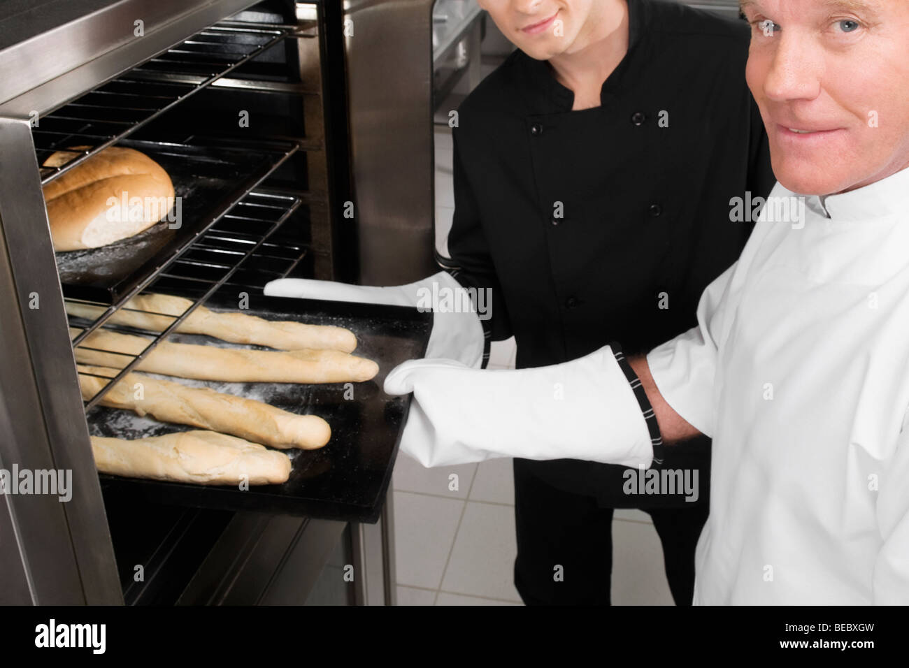 Two chefs preparing food in the kitchen Stock Photo - Alamy