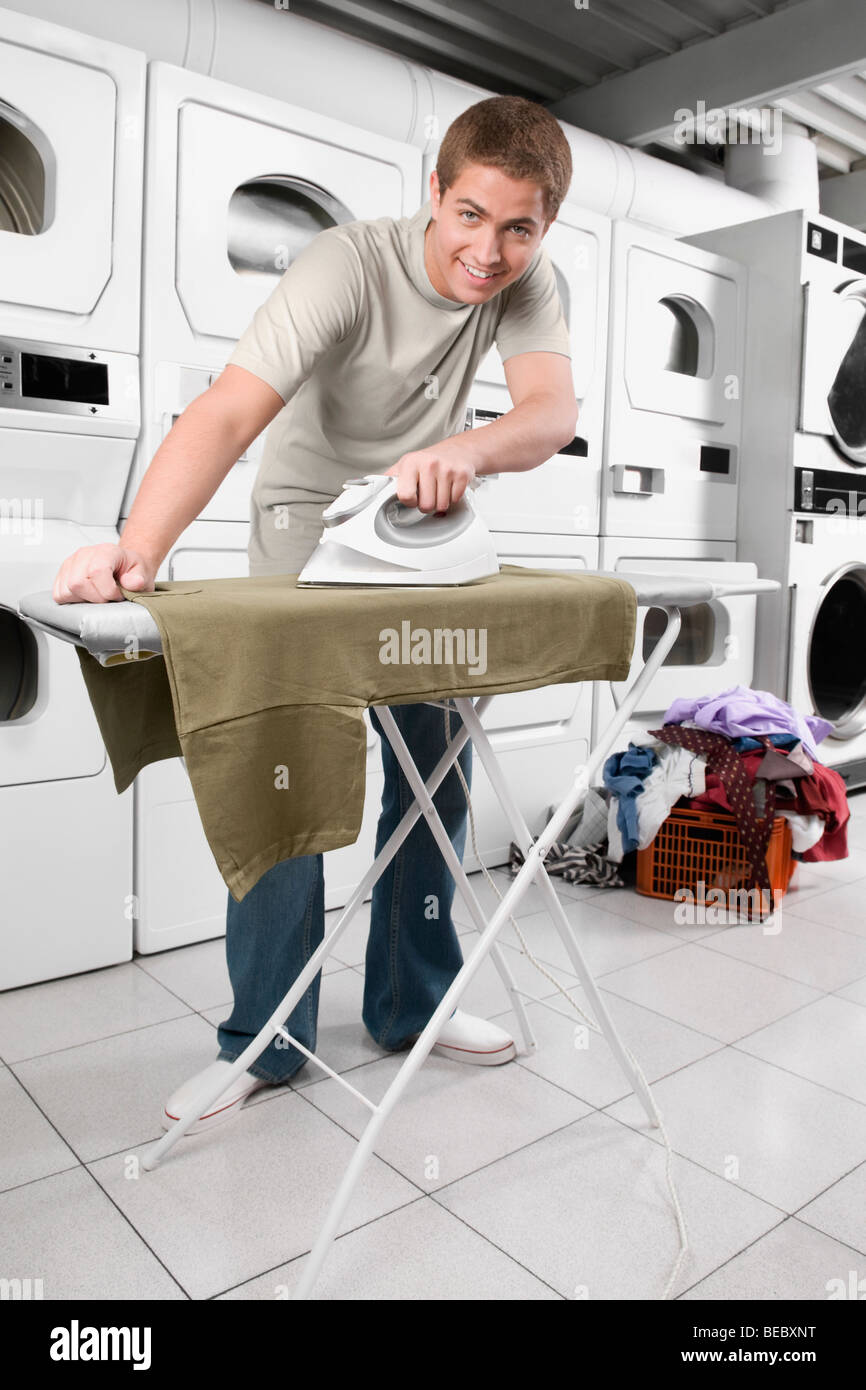 Hispanic man ironing holding hi-res stock photography and images - Alamy