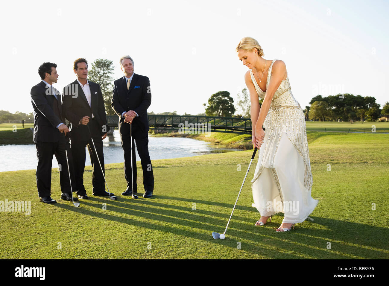 Bride playing golf and three men watching her, Biltmore Golf Course ...