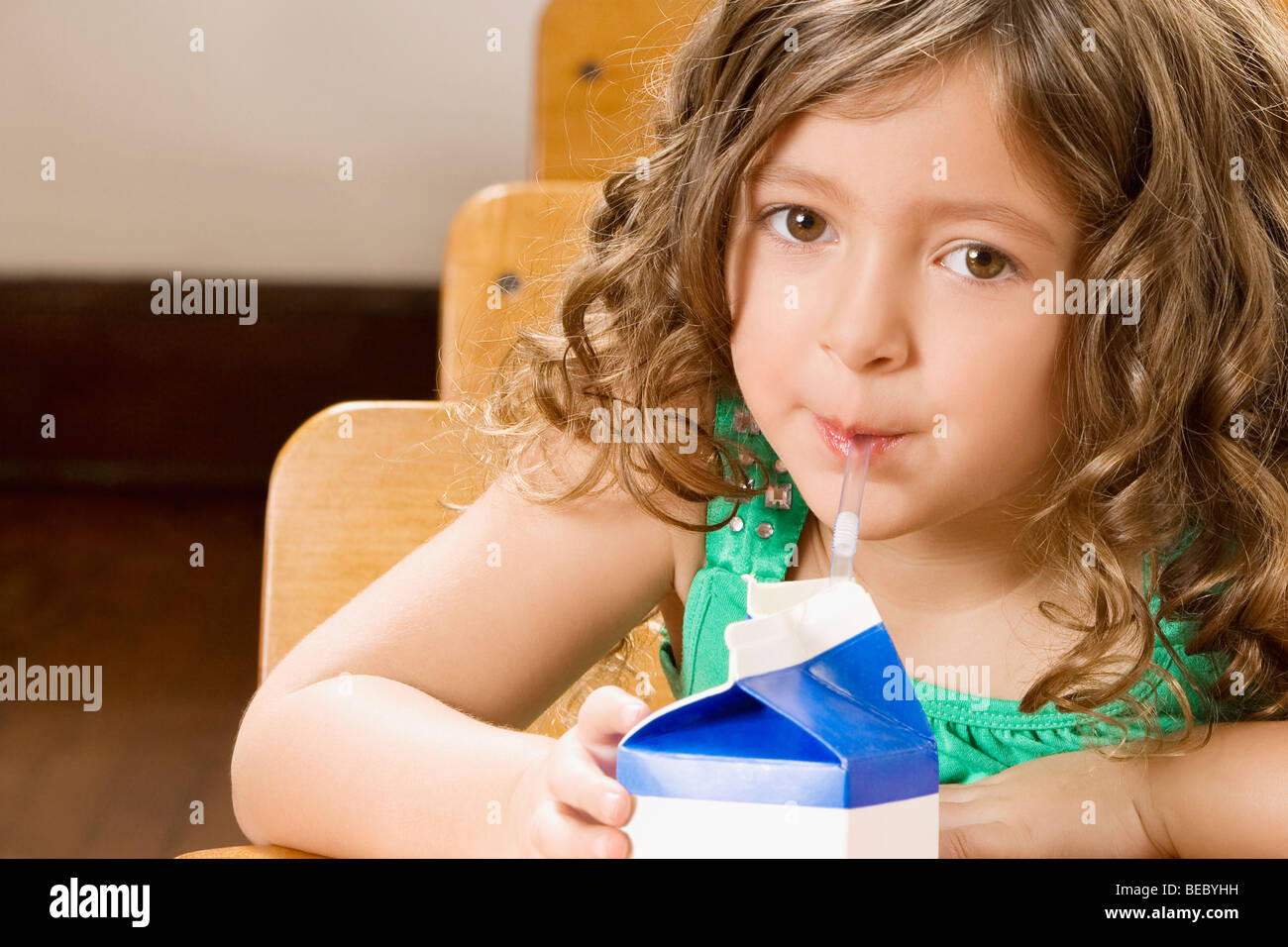 Schoolgirl drinking juice in a classroom Stock Photo - Alamy