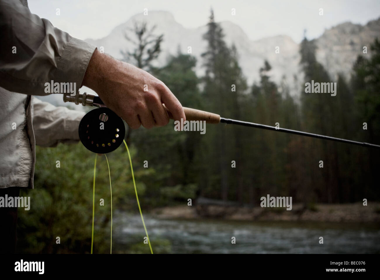 Man holding a fishing rod Stock Photo - Alamy