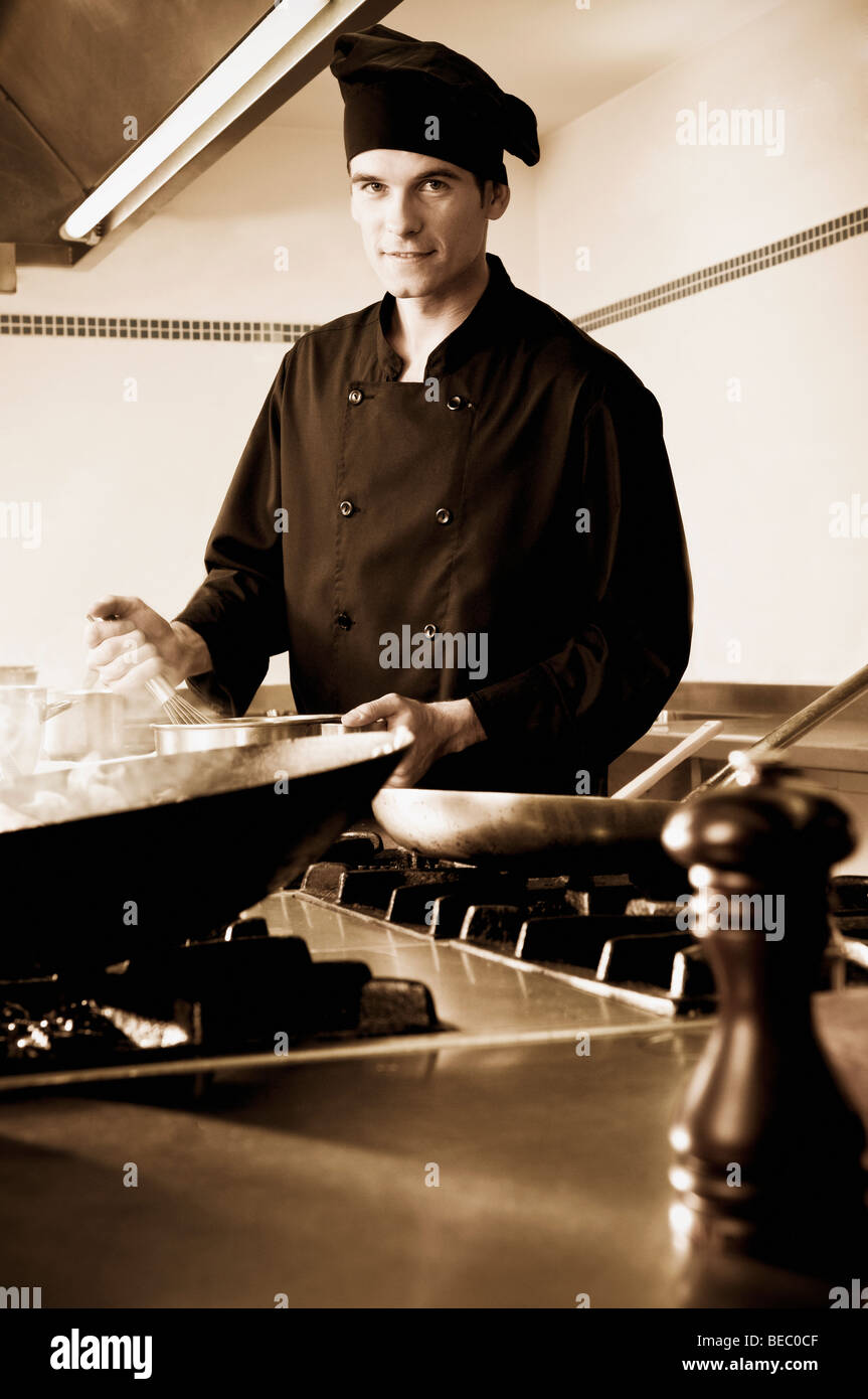 Chef cooking food in the kitchen Stock Photo - Alamy