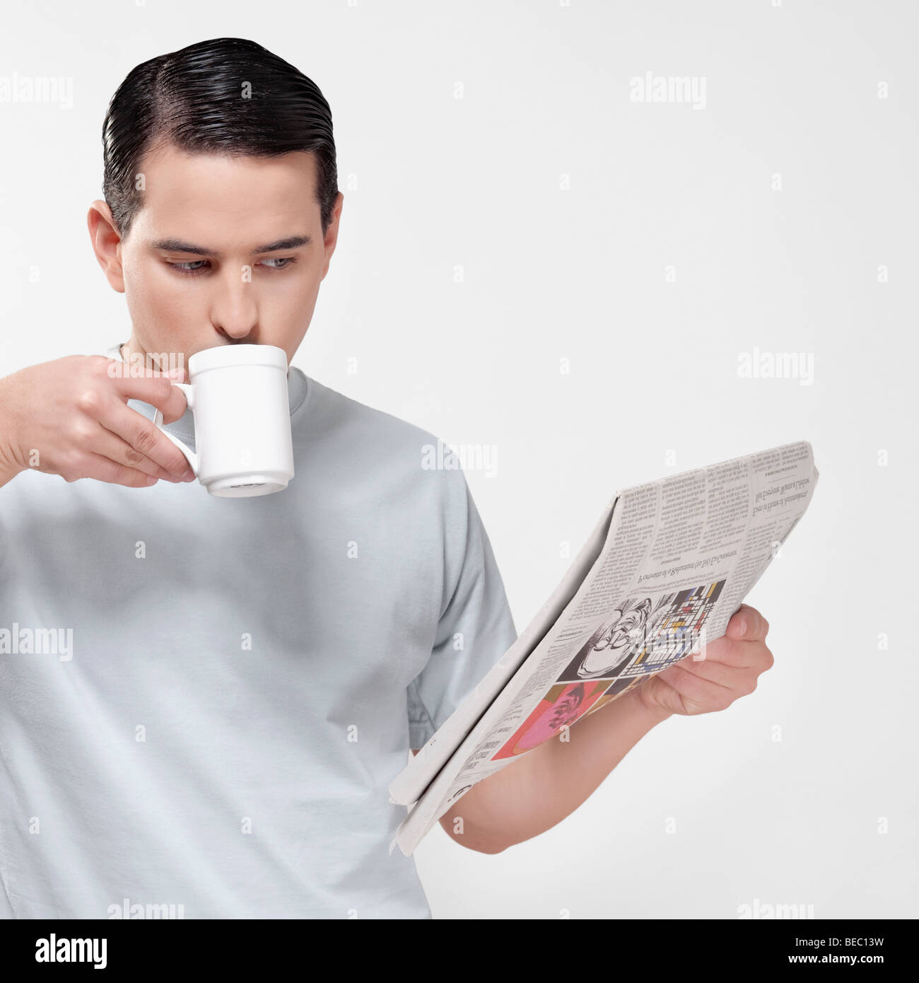 Close-up of a man reading a newspaper and drinking coffee Stock Photo ...