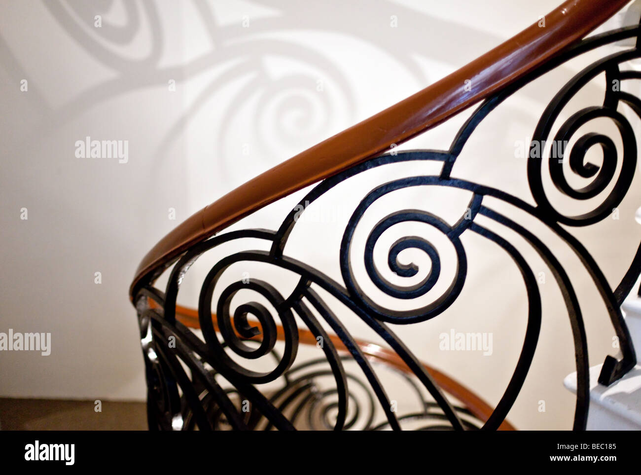 modern metal grate with smooth wood rail on a stairs Stock Photo - Alamy