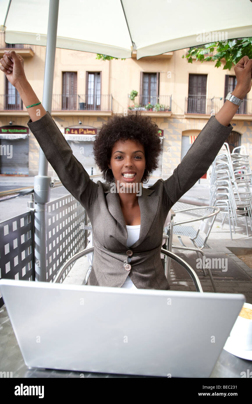 Excited business woman at her laptop Stock Photo - Alamy